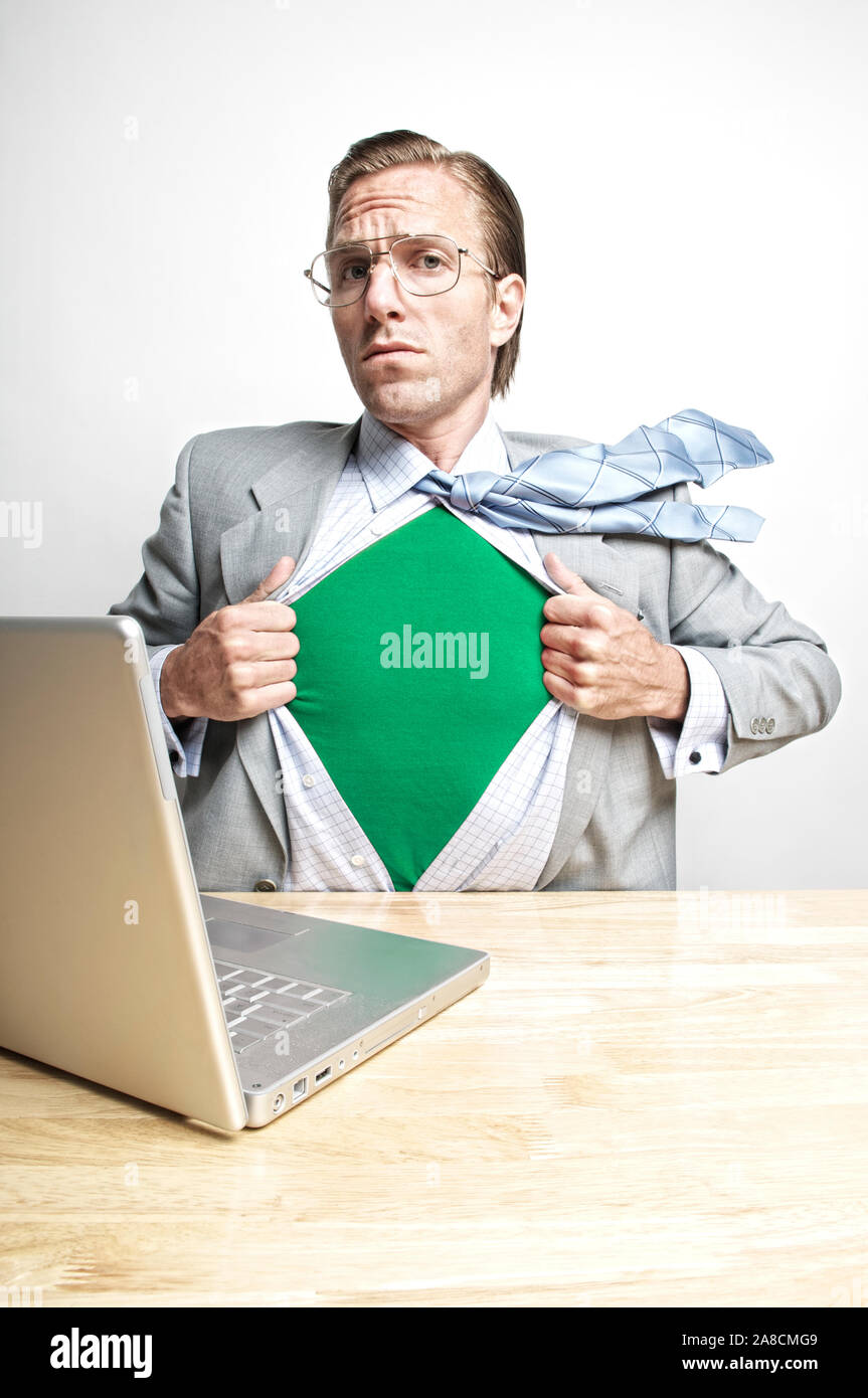 Businessman revealing his green superhero identity sitting in front of ...
