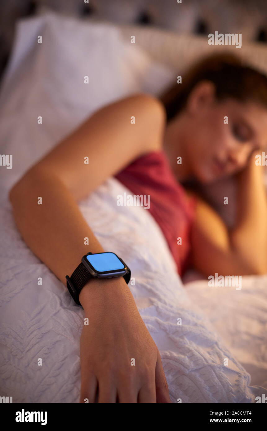 Woman Sleeping In Bed With Focus On Smart Watch She Is Wearing Stock ...