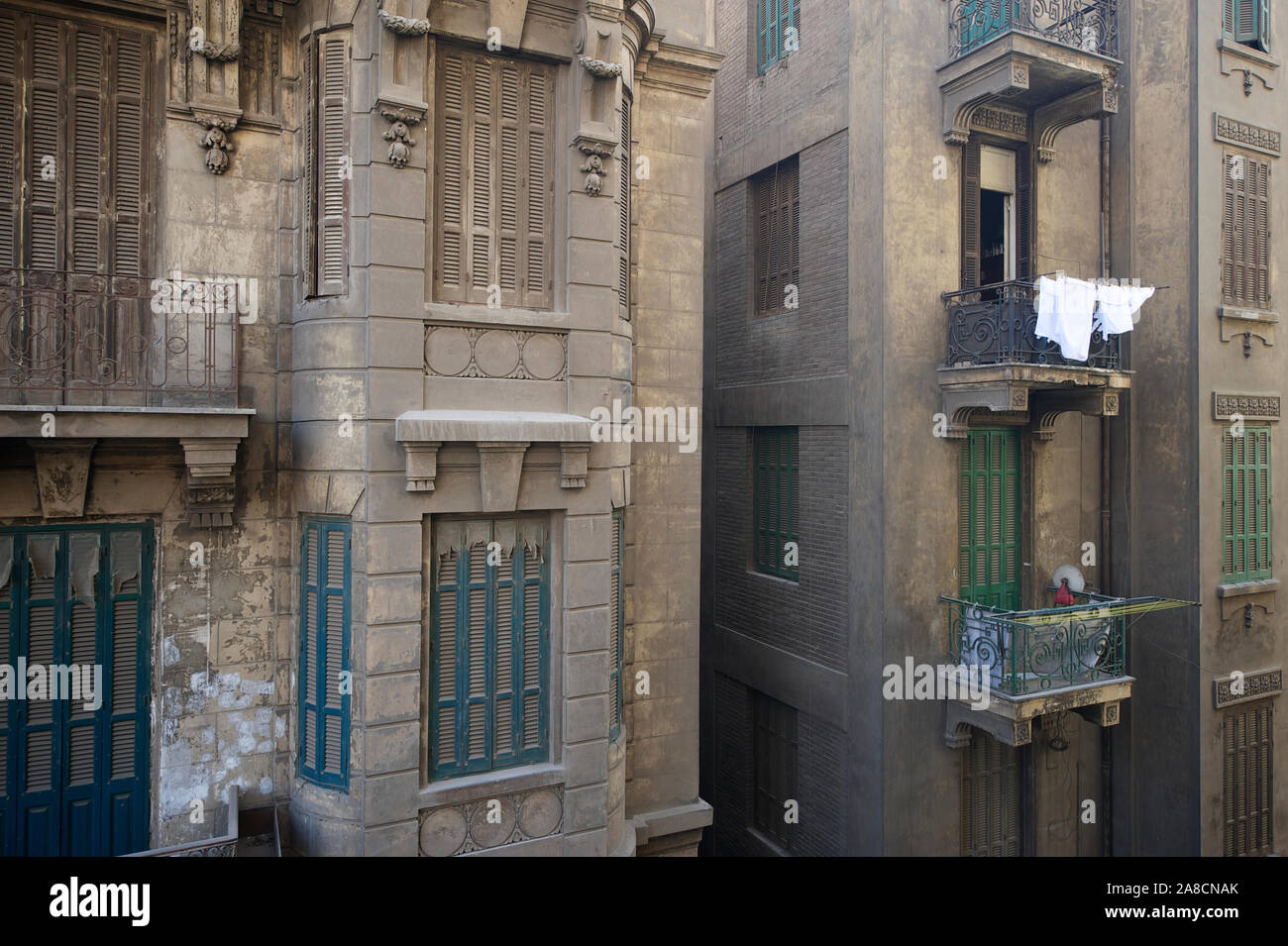 Laundry hangs from balcony of dusty buildings in the center of Cairo ...