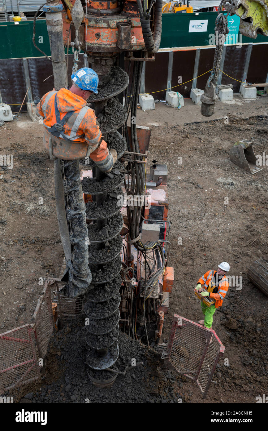 Watched by a colleague on the ground who controls the machinery, a ...