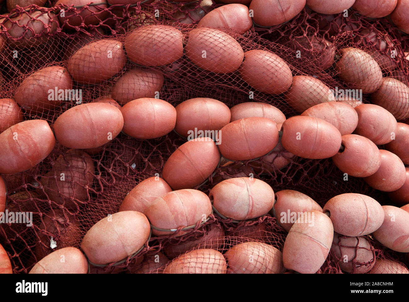 Tangled pile of red plastic fishing nets with Expanded Polystyrene (EPS ...