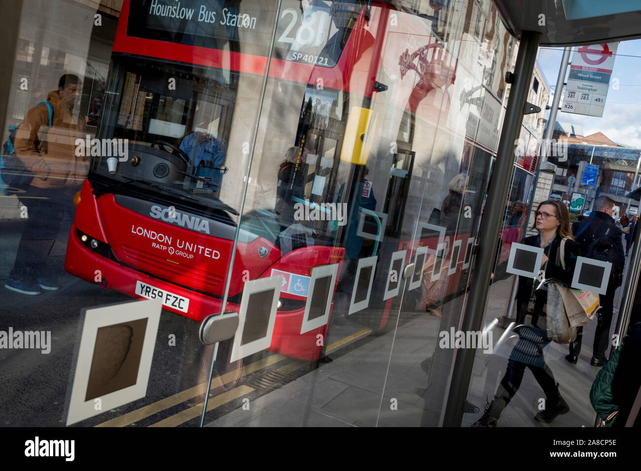 Passengers board a London bus at a bus stop in Kingston, on 7th ...