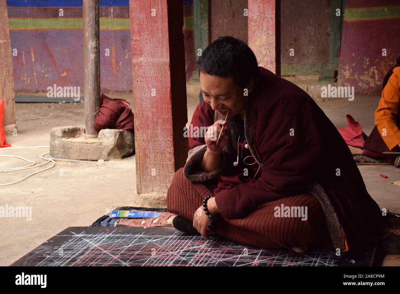 Buddhist monk practicing drawing a mandala inside Sakya monastery ...