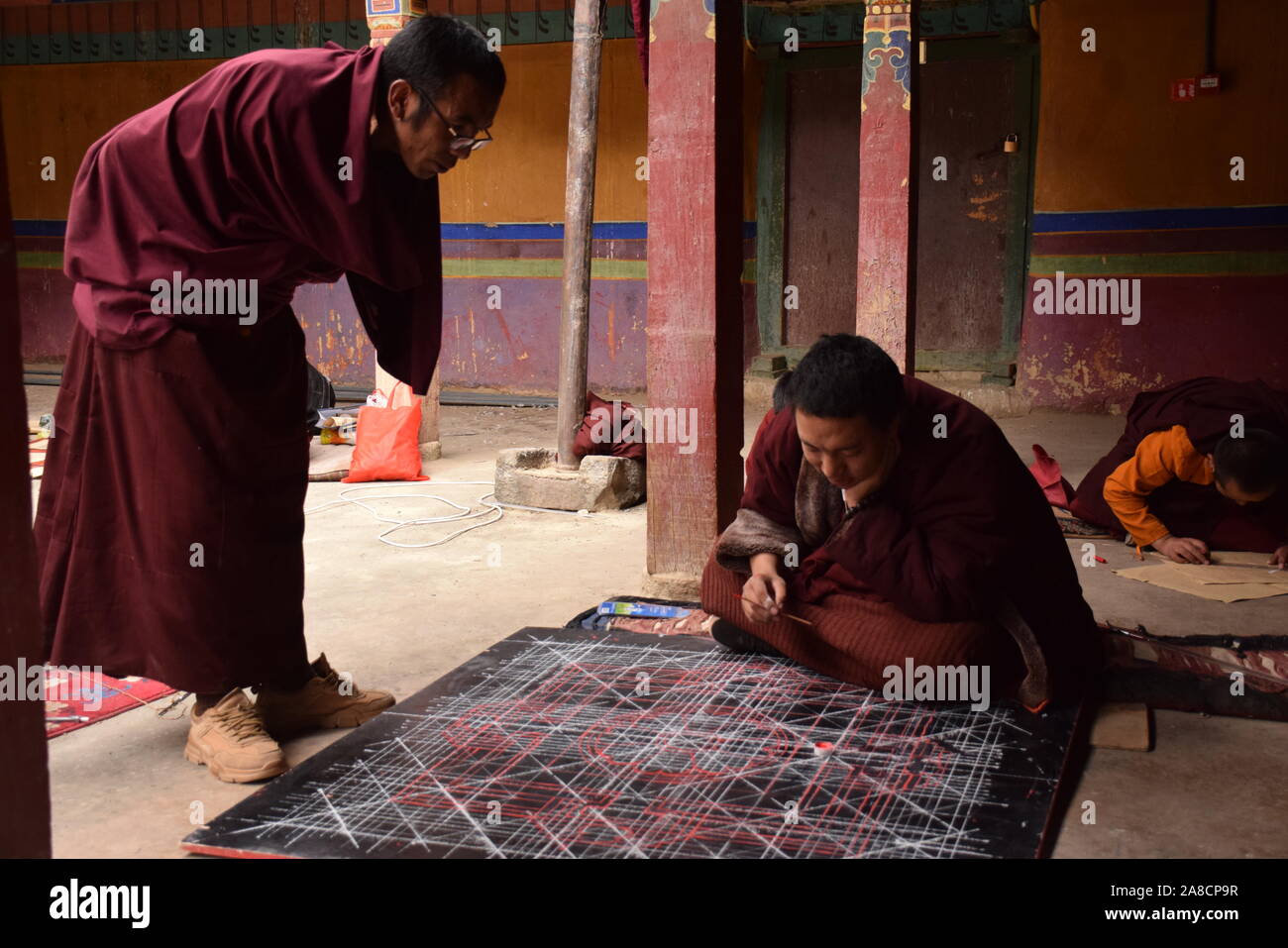 Buddhist monk practicing drawing a mandala inside Sakya monastery ...