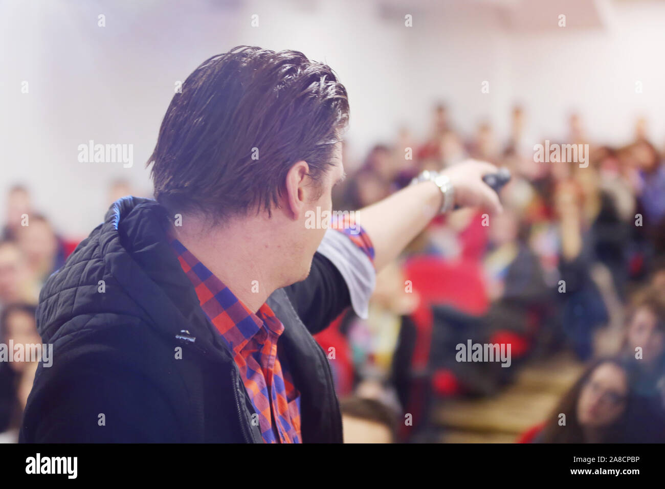 Young businessman at business conference room with public giving ...