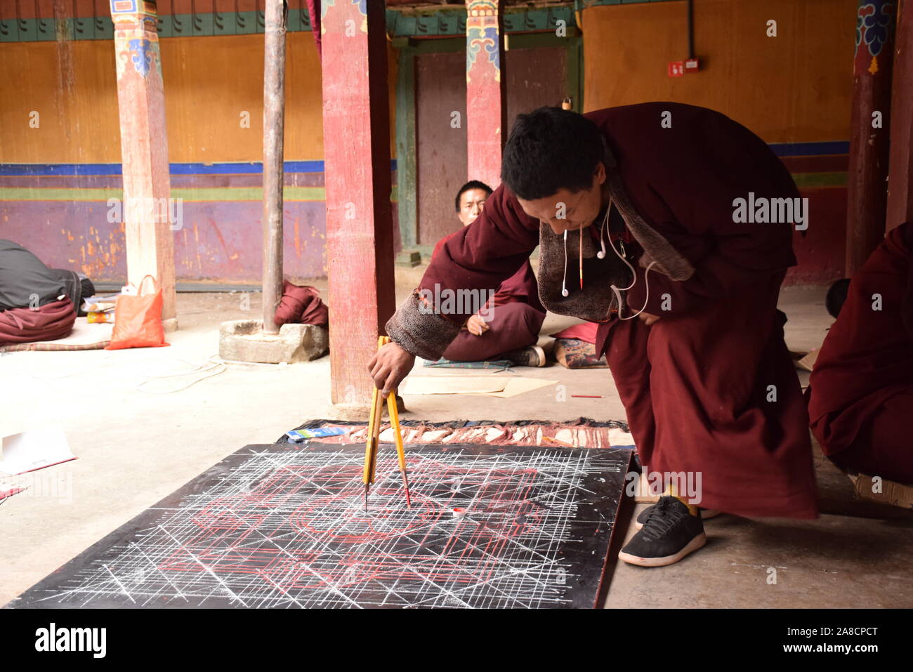 Buddhist monk practicing drawing a mandala inside Sakya monastery ...