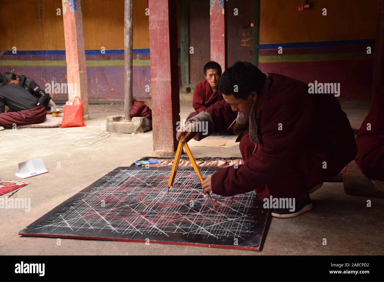 Buddhist monk practicing drawing a mandala inside Sakya monastery ...