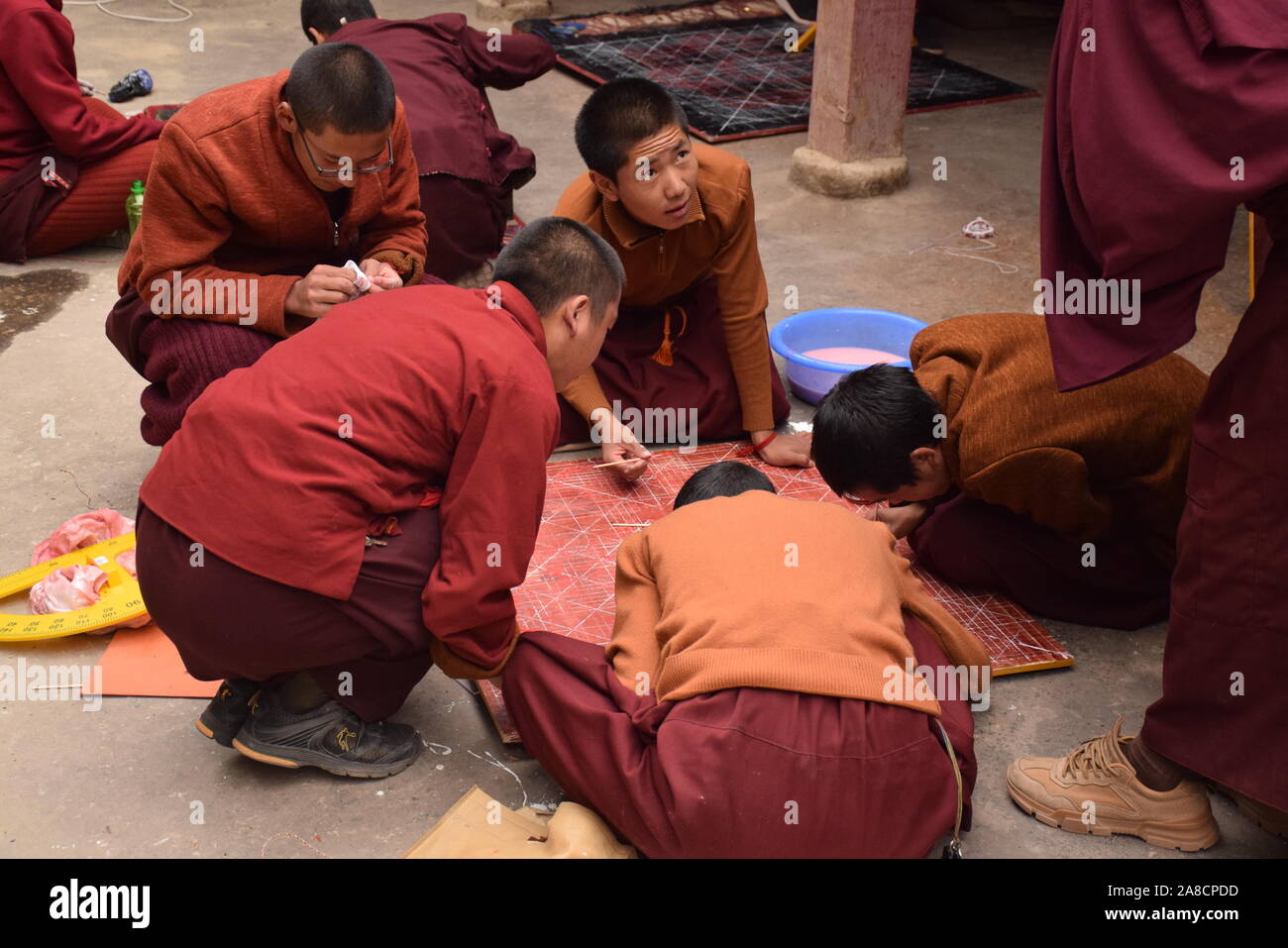 Buddhist monks practicing drawing a mandala inside Sakya monastery ...