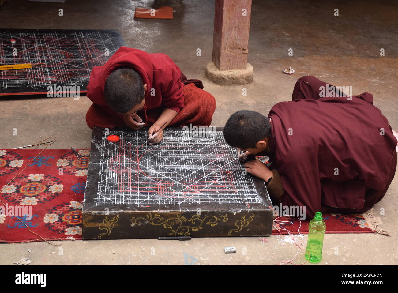 Buddhist monks practicing drawing a mandala inside Sakya monastery ...