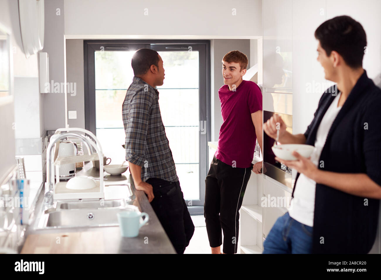 Group Of Male College Students Eating Breakfast And Hanging Out In ...
