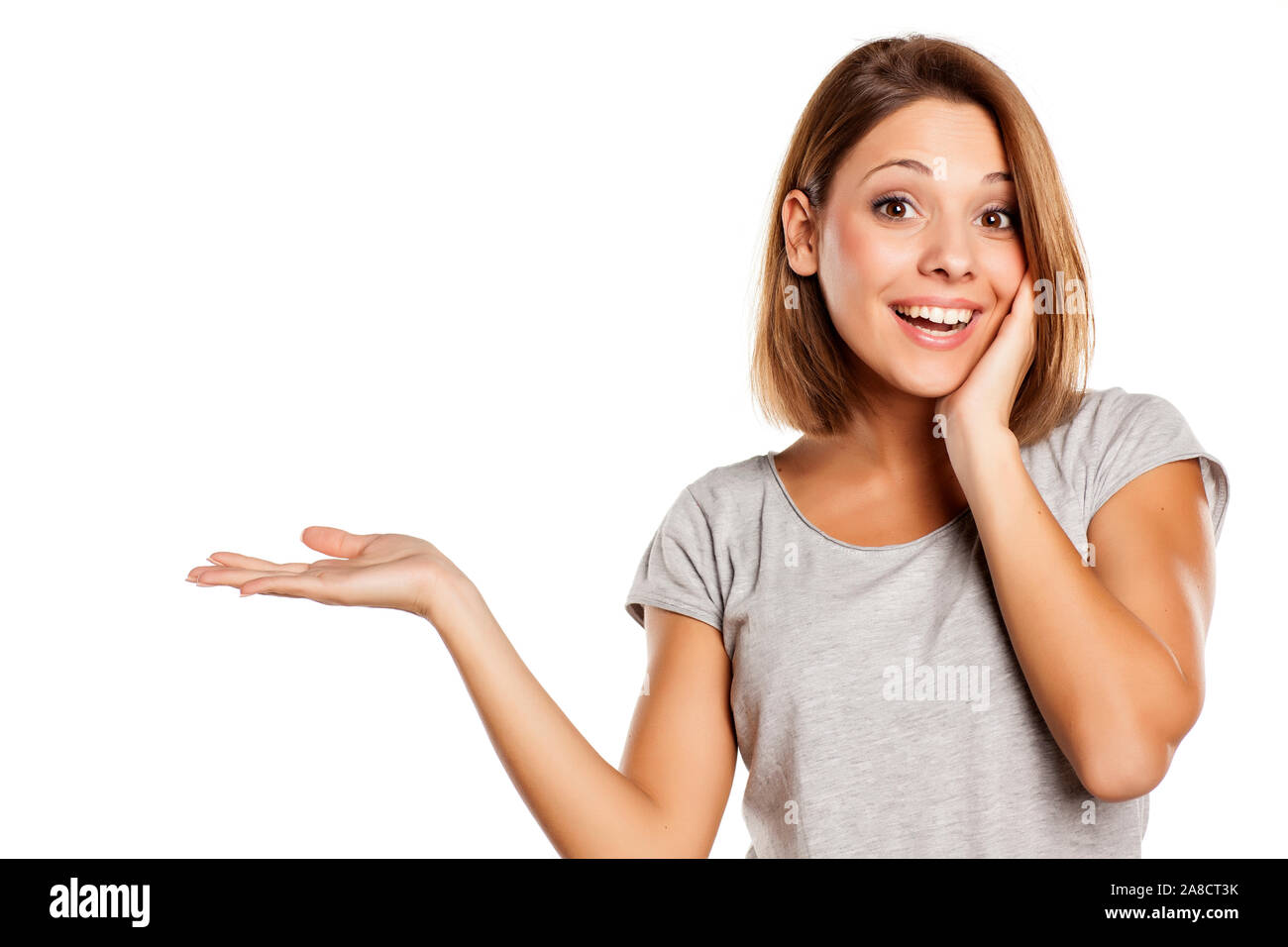 young beautiful woman in gray shirt , holding imaginary object on the ...