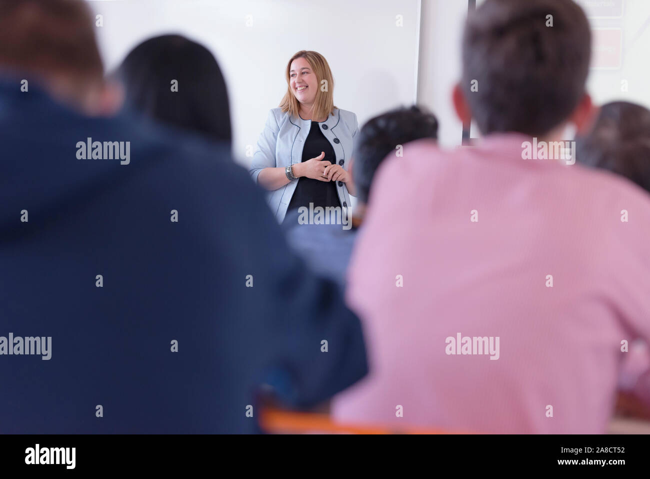 Female professor explain to students and interact with them in the ...