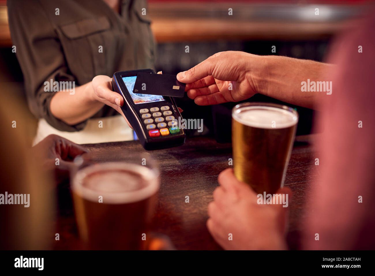 Person paying for drinks credit card hi-res stock photography and ...