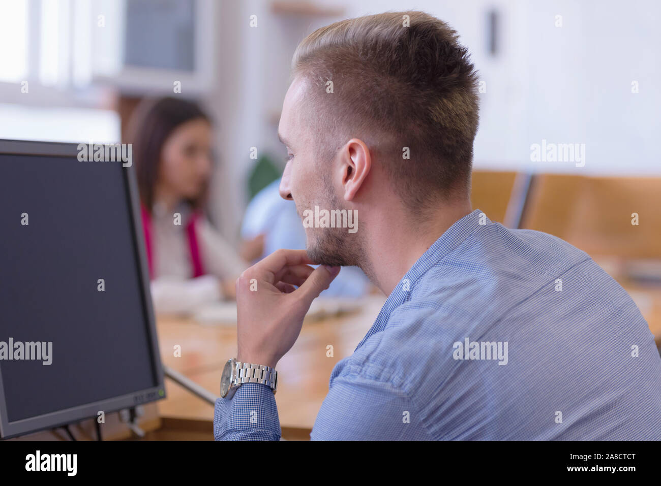Male university student work at computer lab at university, campus ...