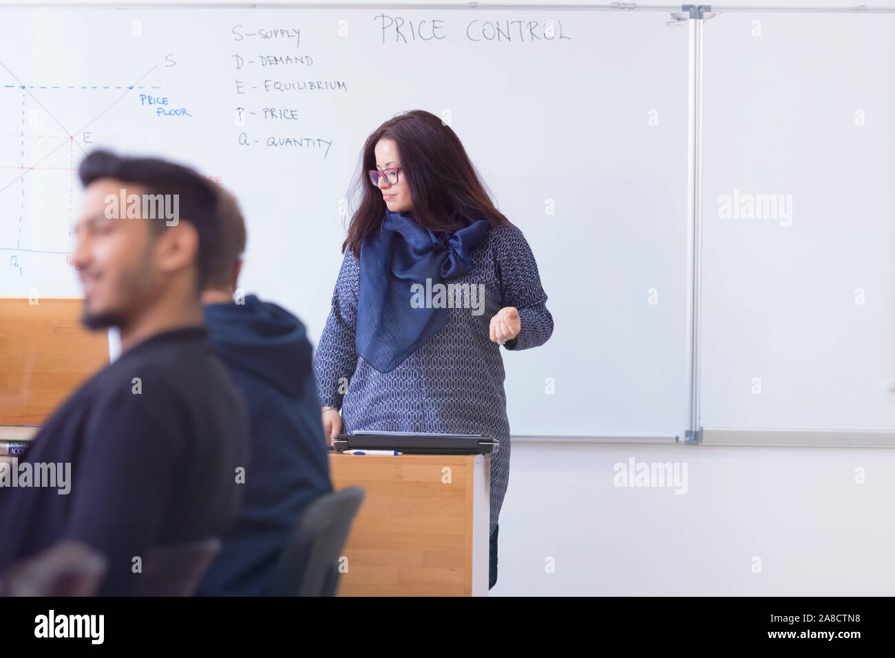 Female professor explain to students and interact with them in the ...