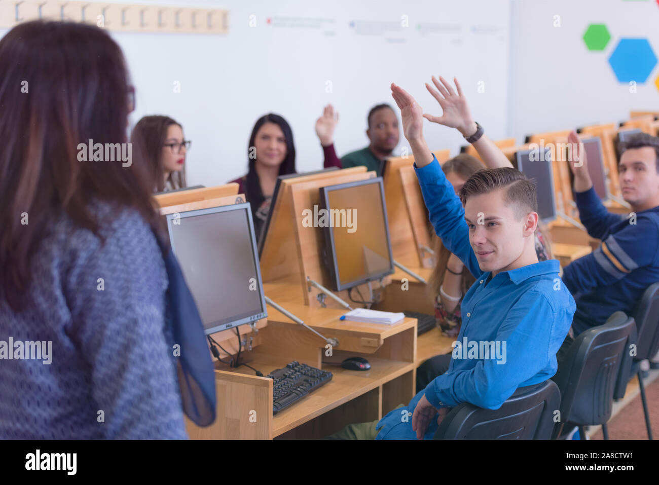 Female professor explain to students and interact with them in the ...