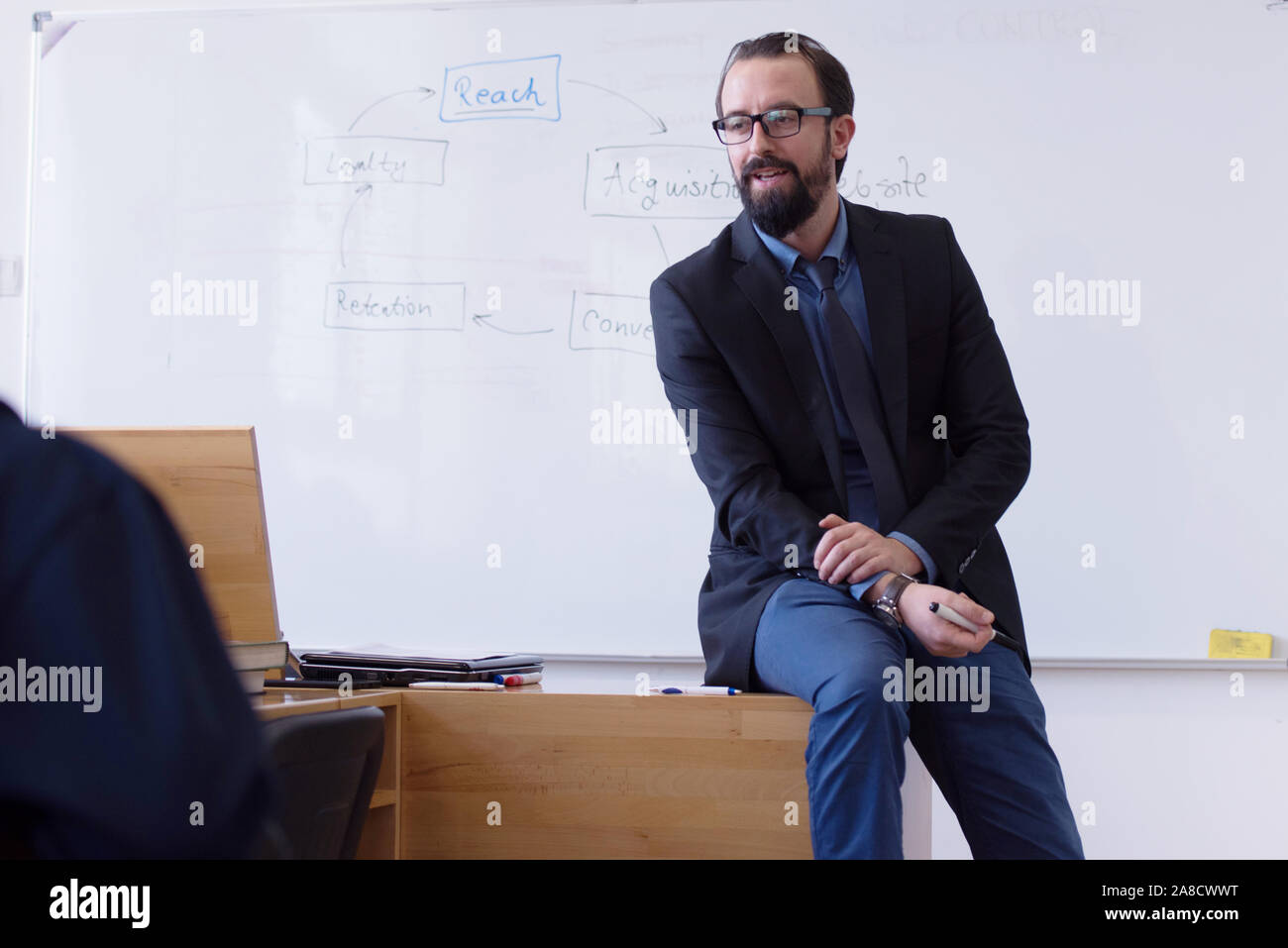 Group of students study with professor in modern school classroom. Male ...