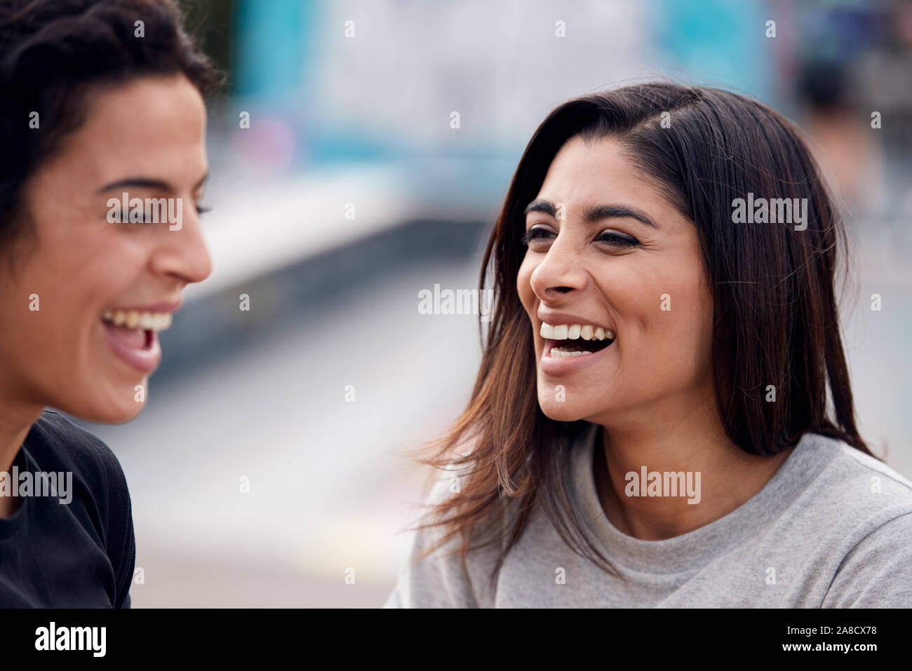 Two Female Friends Meeting In Urban Skate Park Stock Photo - Alamy
