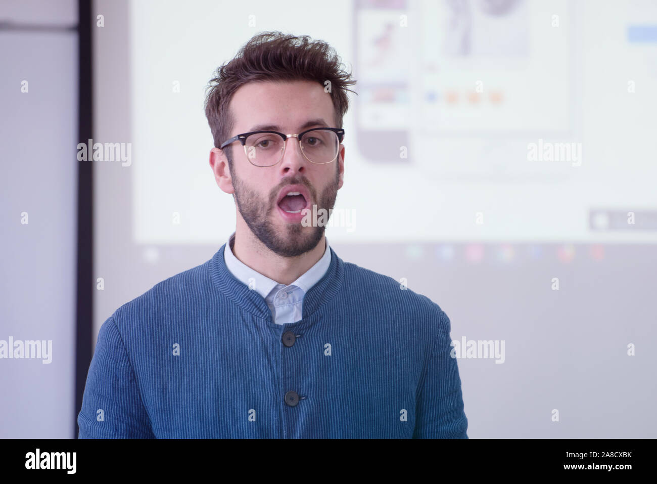 Portrait of male teacher at work. Male professor explain to students ...