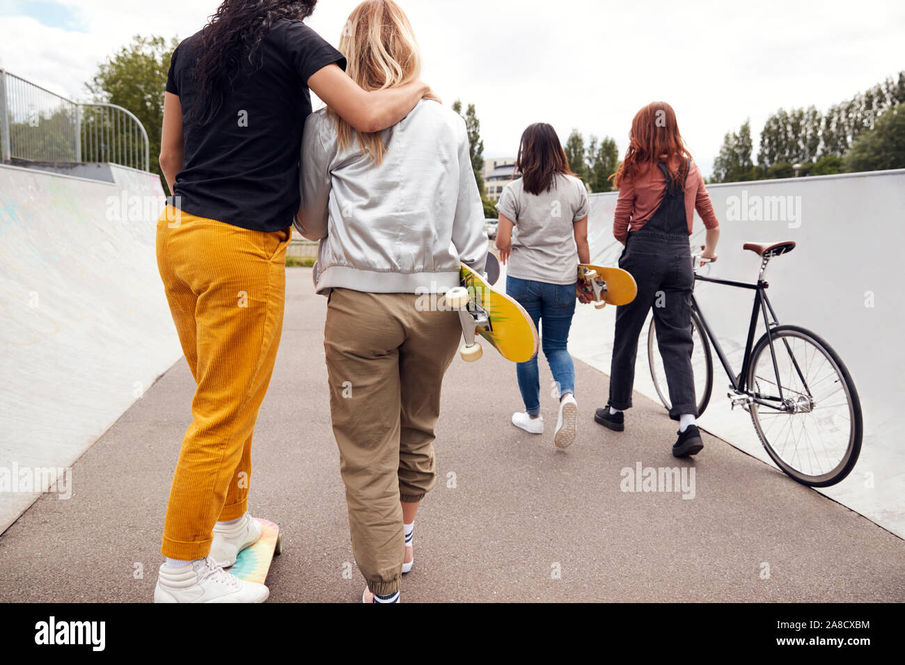 Skateboard walking behind hi-res stock photography and images - Alamy