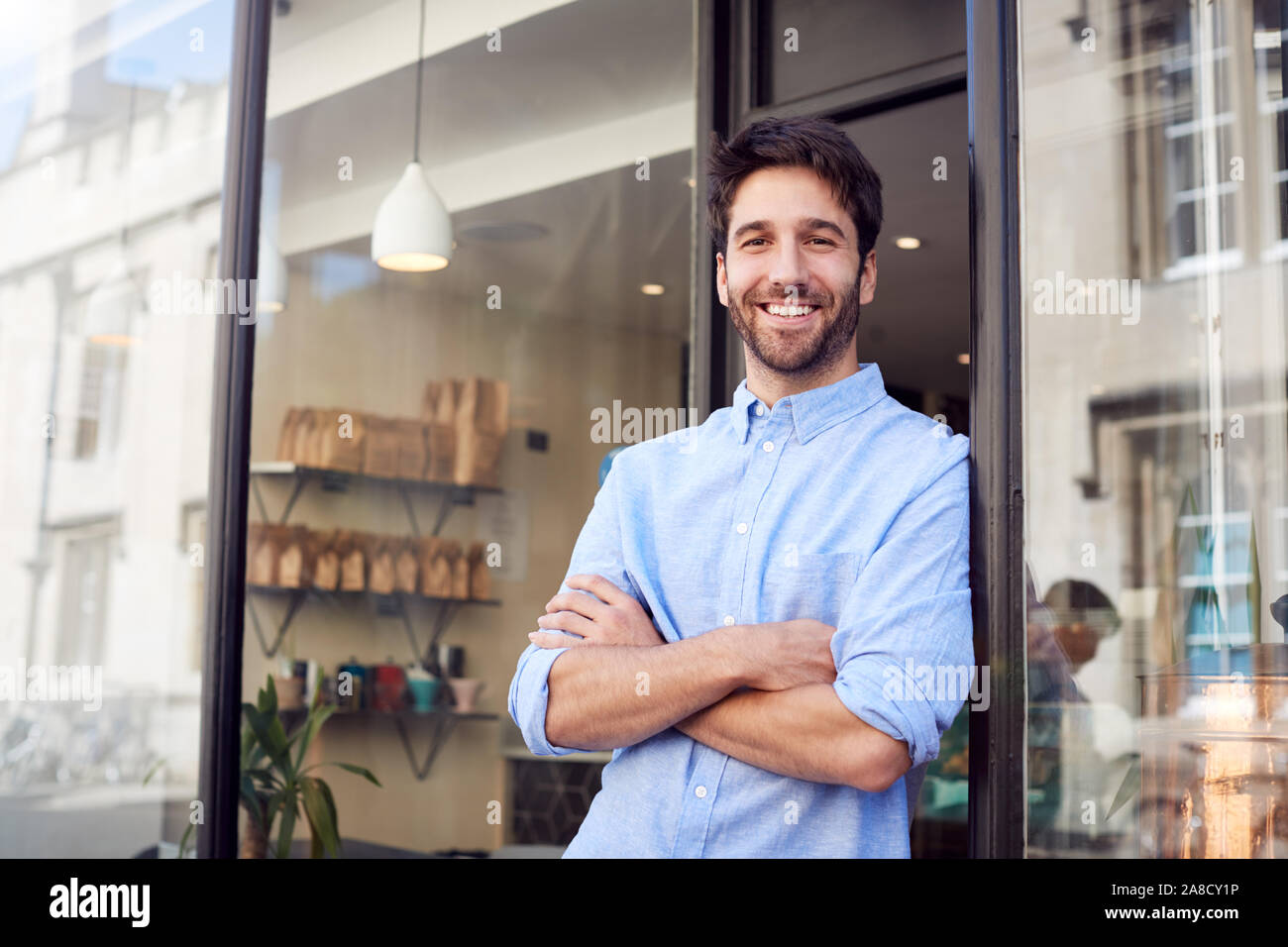Portrait Of Male Owner Standing Outside Coffee Shop Stock Photo - Alamy