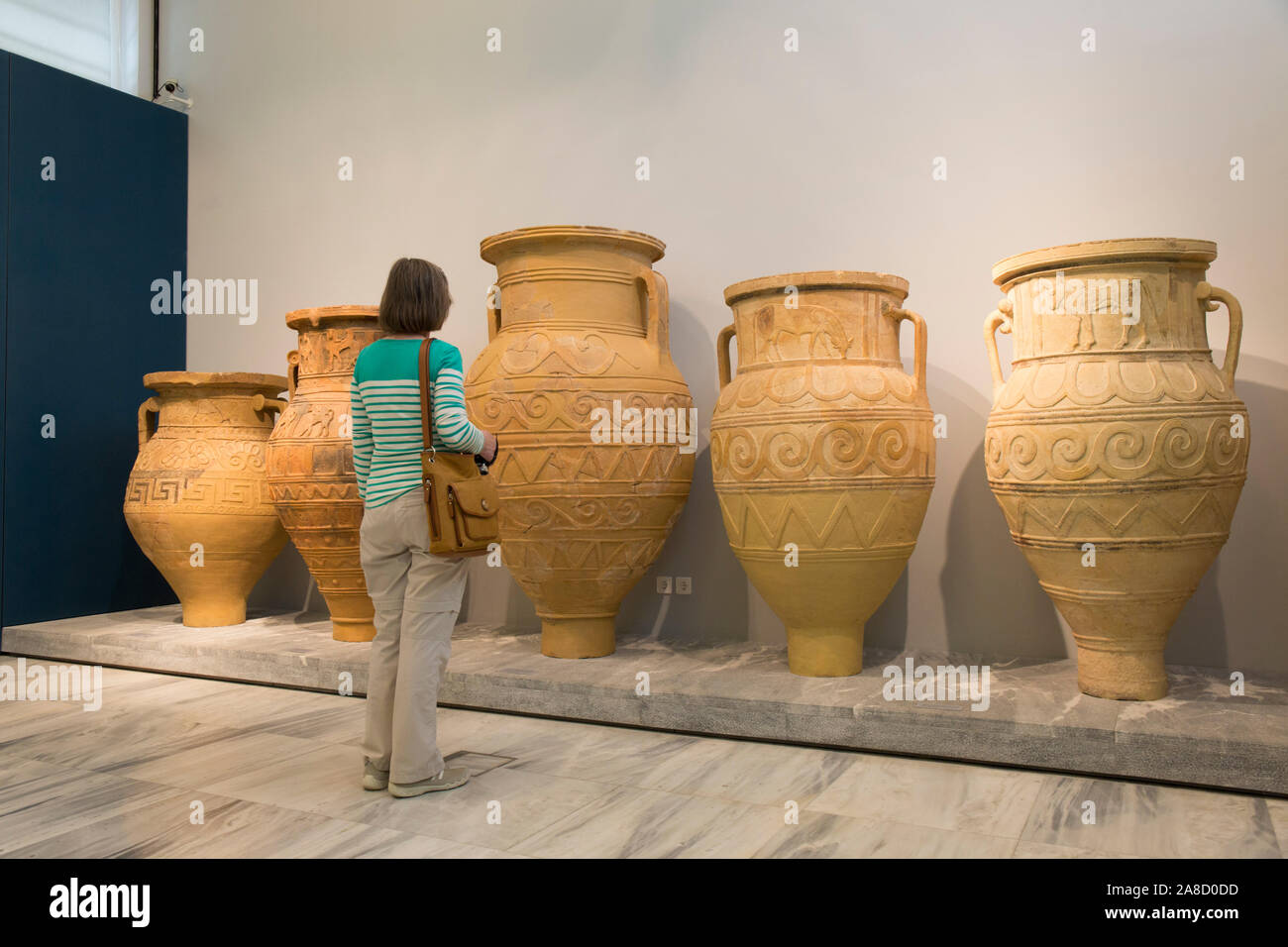 Heraklion, Crete, Greece. Visitor admiring giant earthenware storage ...