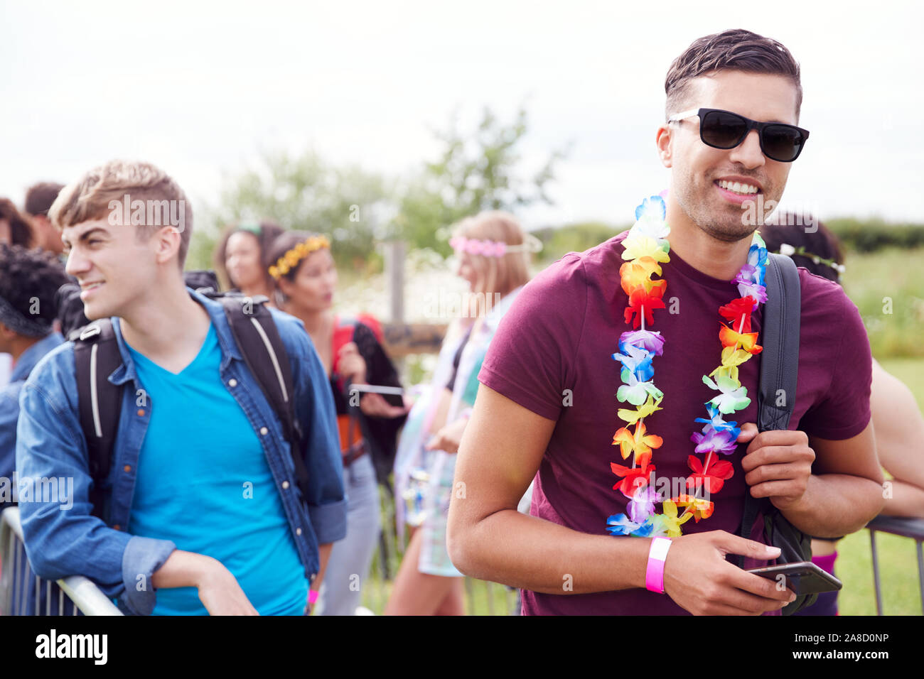 People waiting behind barrier hi-res stock photography and images - Alamy