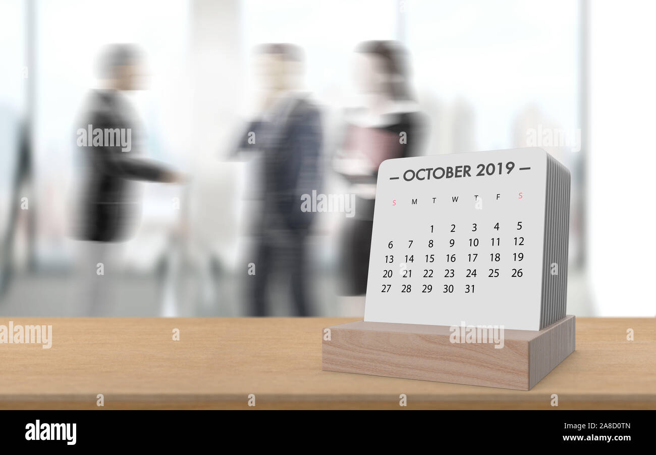 October 2019 calendar on a brown wooden table In front of shiny modern ...