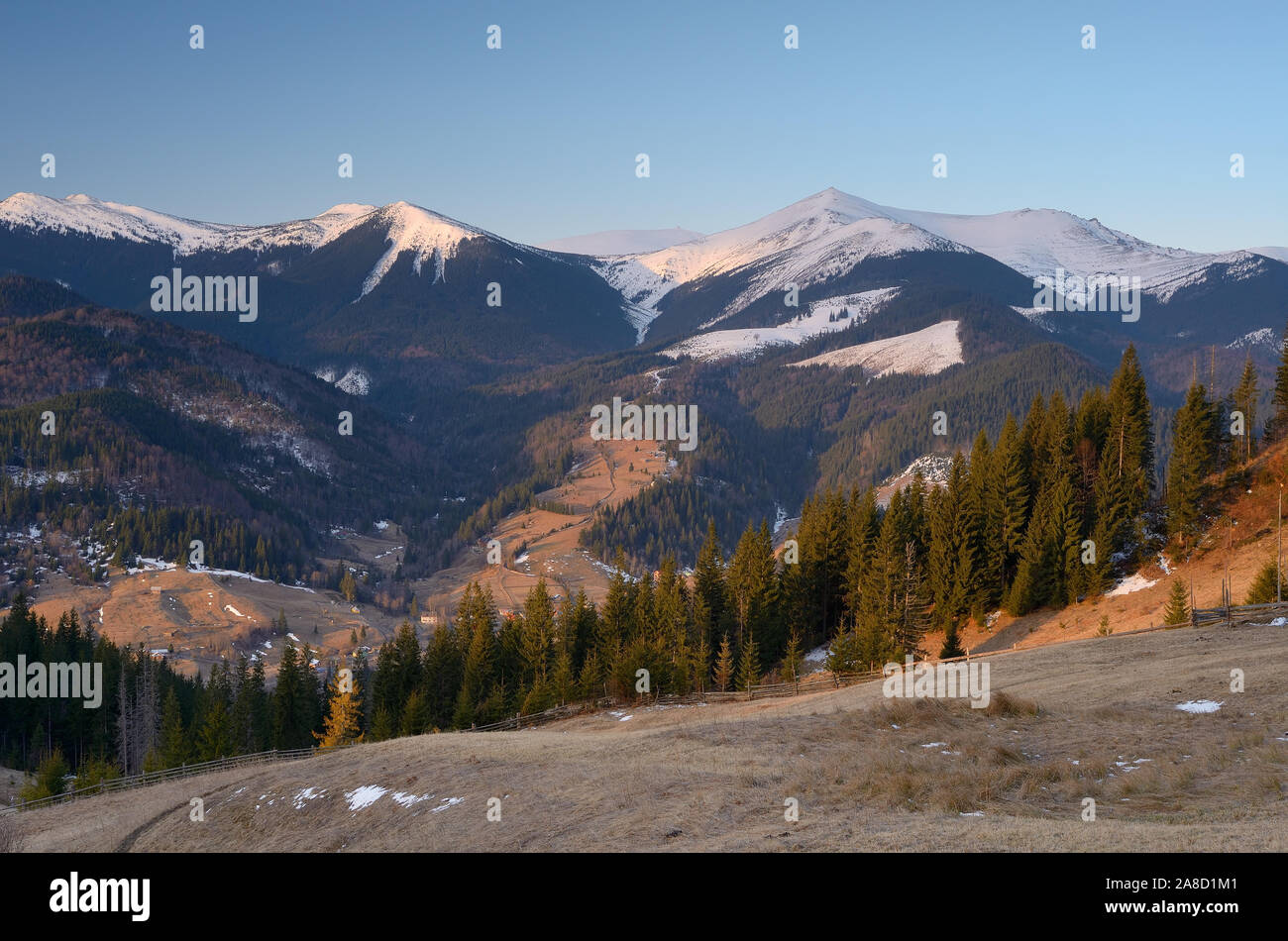Spring landscape with a view of the mountain village. The last snow on ...
