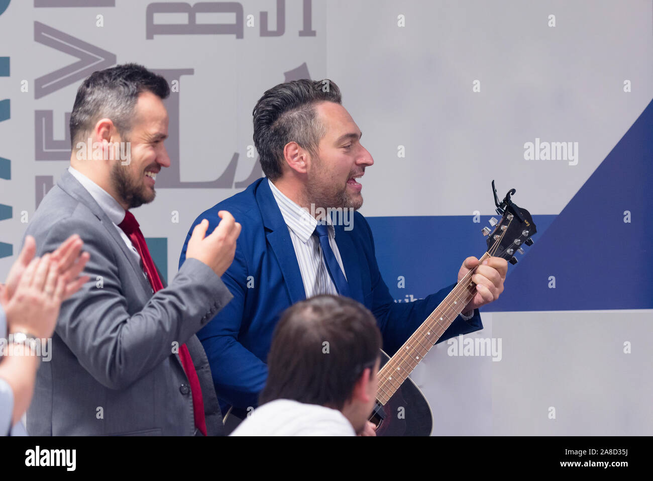 Happy friends doing party playing guitar Stock Photo - Alamy