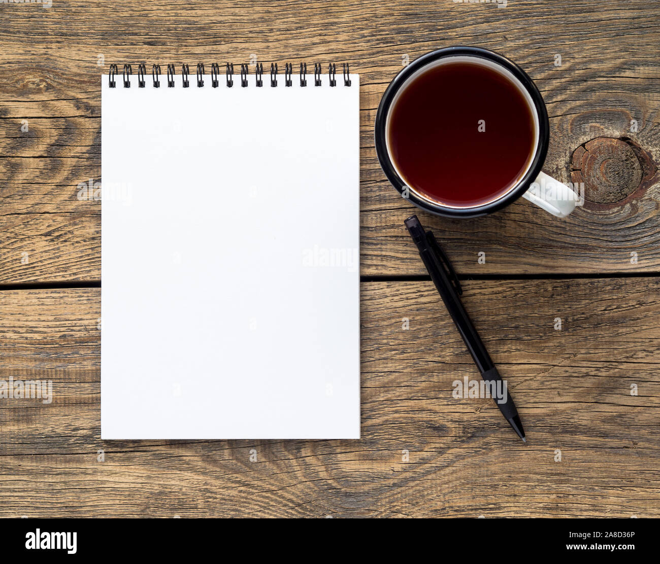 Open notebook on a spring with a white paper for notes and drawing near ...