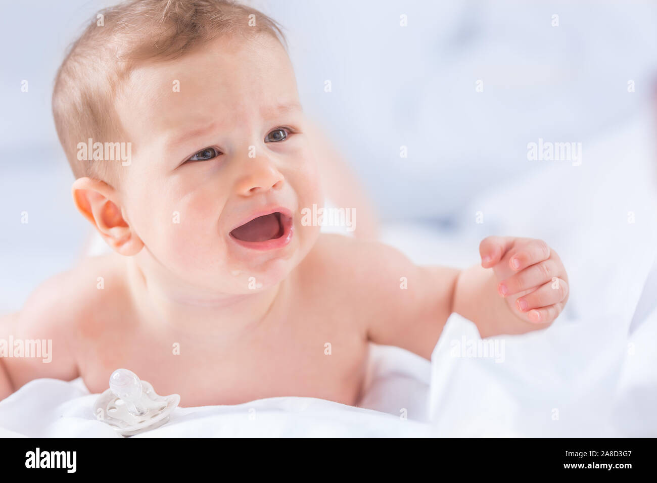 Small family with one child lies on the bed hi-res stock photography ...