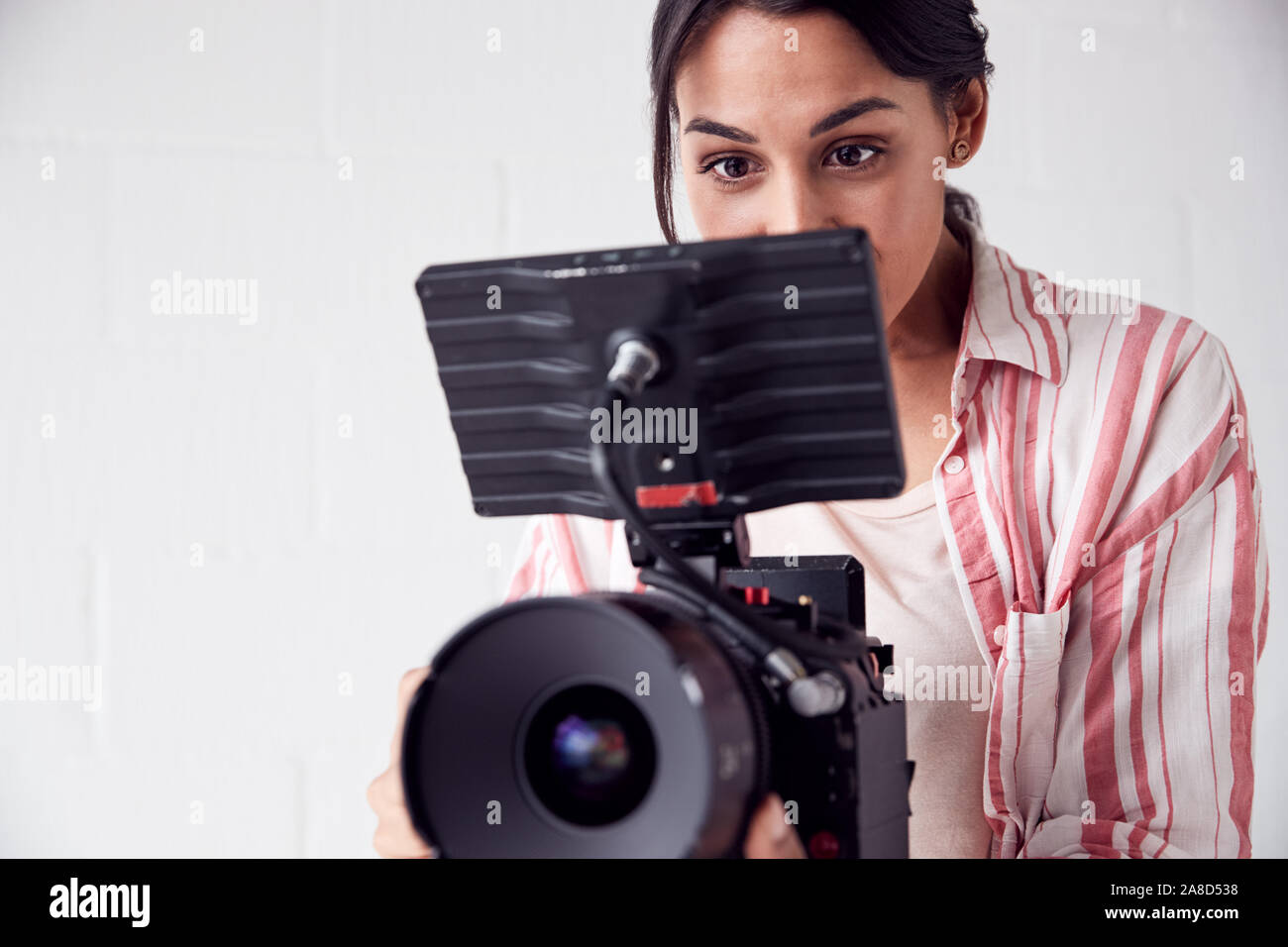 Female Videographer With Video Camera Filming Movie In White Studio ...