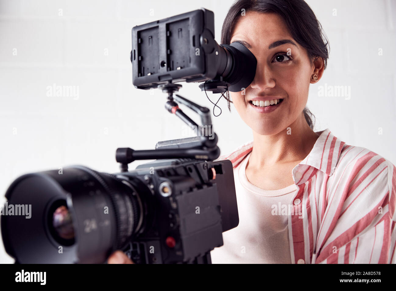 Female Videographer With Video Camera Filming Movie In White Studio ...