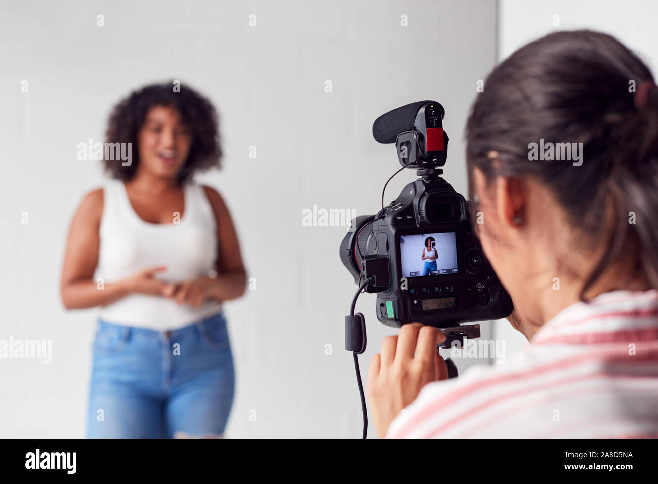 Professional videographer filming interview hi-res stock photography ...