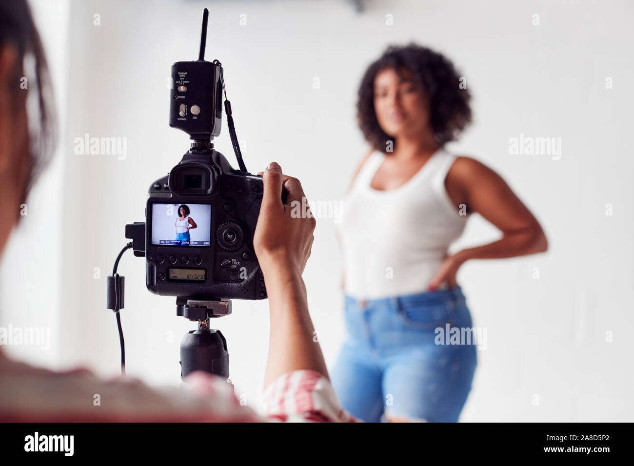 Female Photographer In Digital Studio Shooting Images On Camera ...