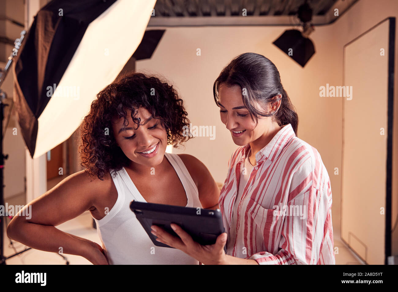 Photographer With Female Client Editing Images From Portrait Photo ...