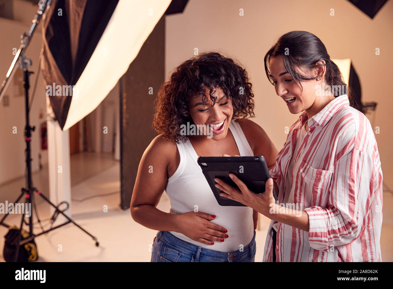 Photographer With Female Client Editing Images From Portrait Photo ...