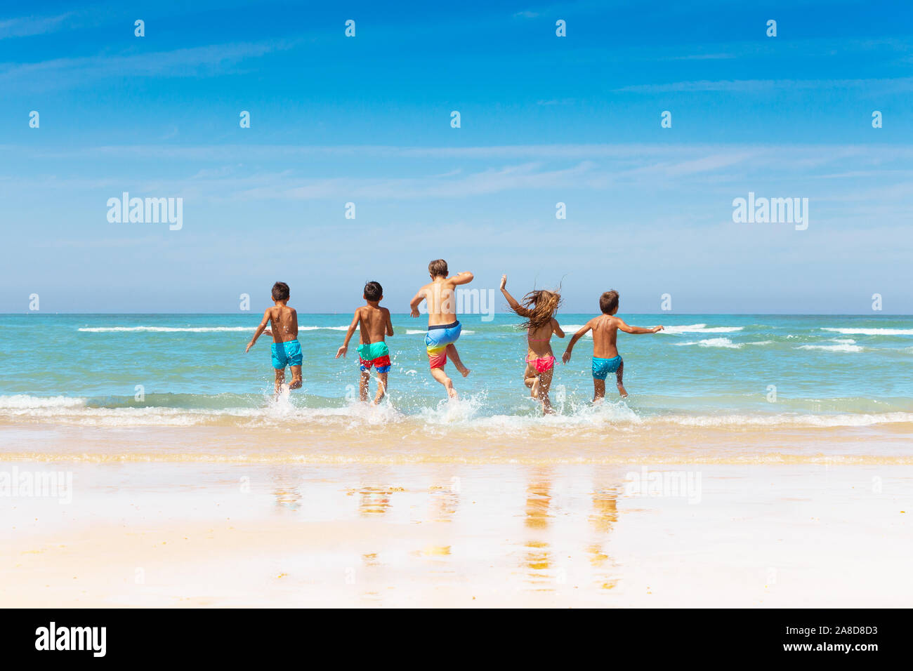 Boys jumping into waves hi-res stock photography and images - Alamy