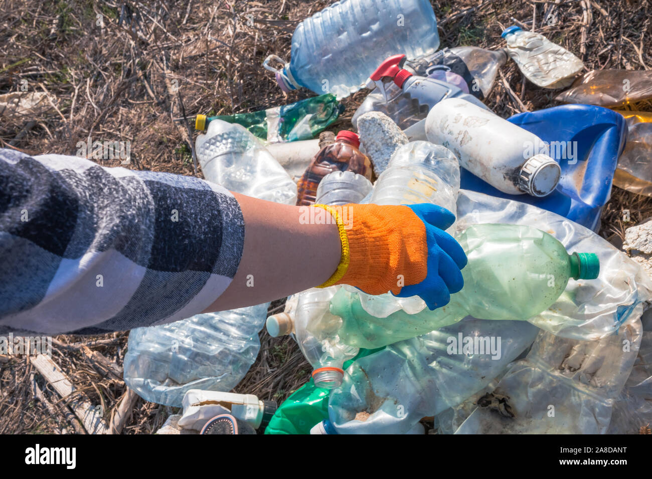 Close up of woman hand collecting plastic garbage. Recycling and ...