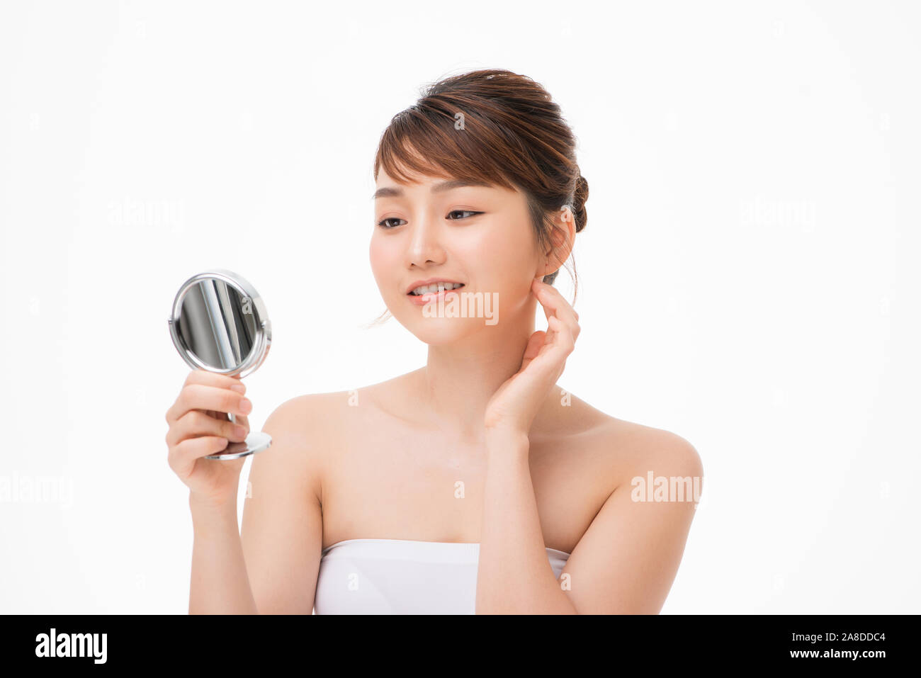 Woman inspecting her skin with a mirror Stock Photo - Alamy