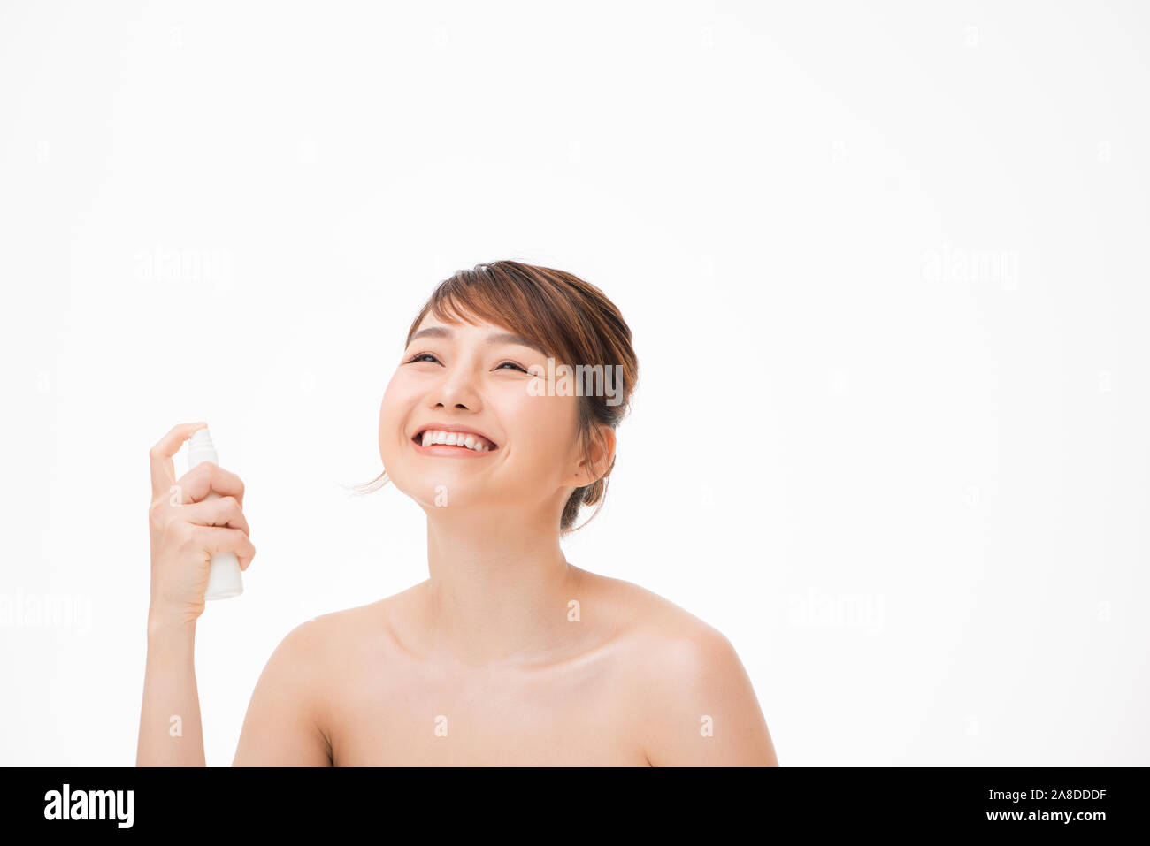 Beautiful woman face spray on face lotion cosmetology on white ...