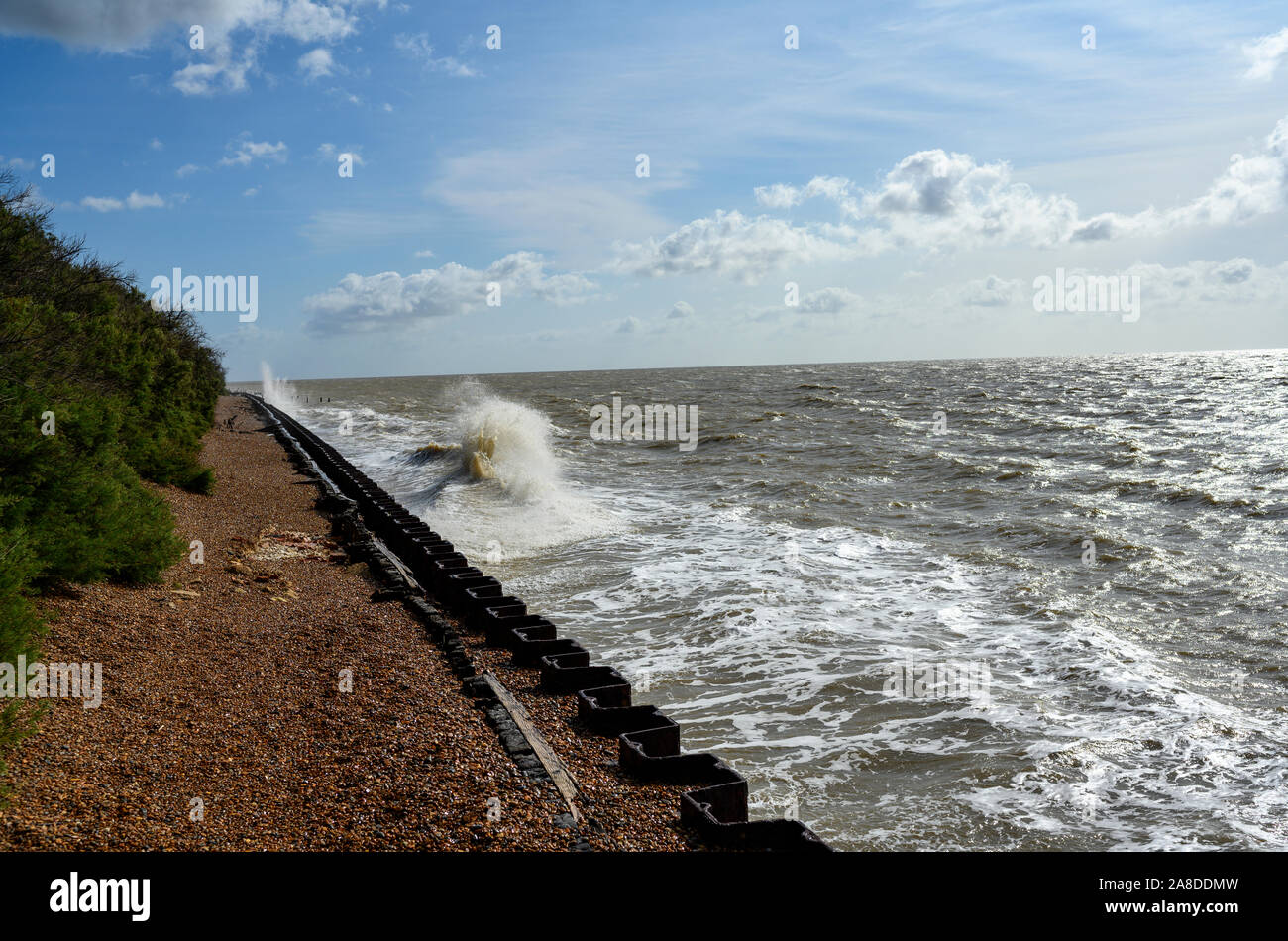 Waves breaking on sea wall Stock Photo - Alamy
