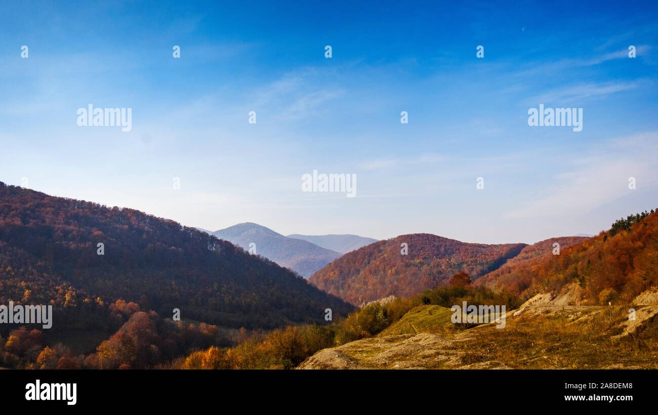 Scenic autumn landscape with mountain peaks and steep valleys in ...