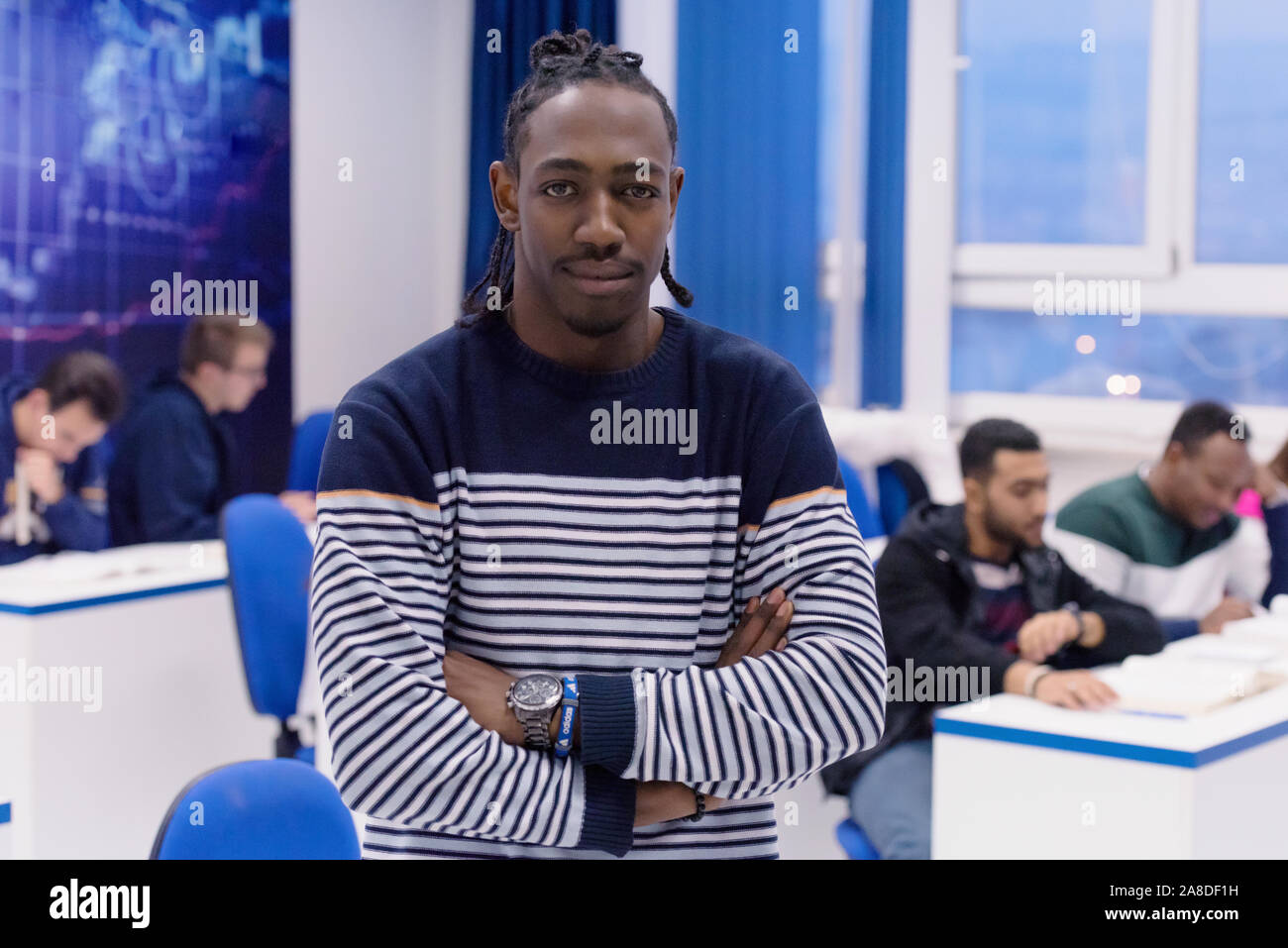 African american university male student in class smiling at the camera ...