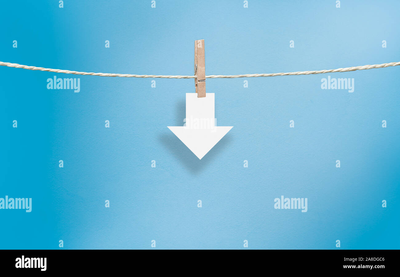 Cut out Arrow Symbol in white cut out paper on blue background. High ...