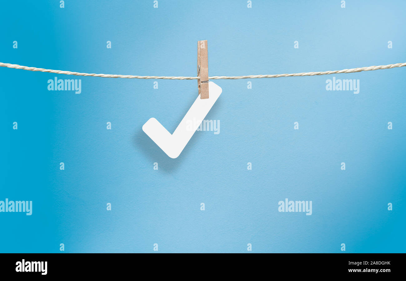 Cut out Check Sign in white cut out paper on blue background. High ...