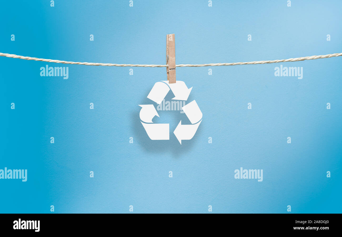 Cut out Recycling icon in white cut out paper on blue background. High ...