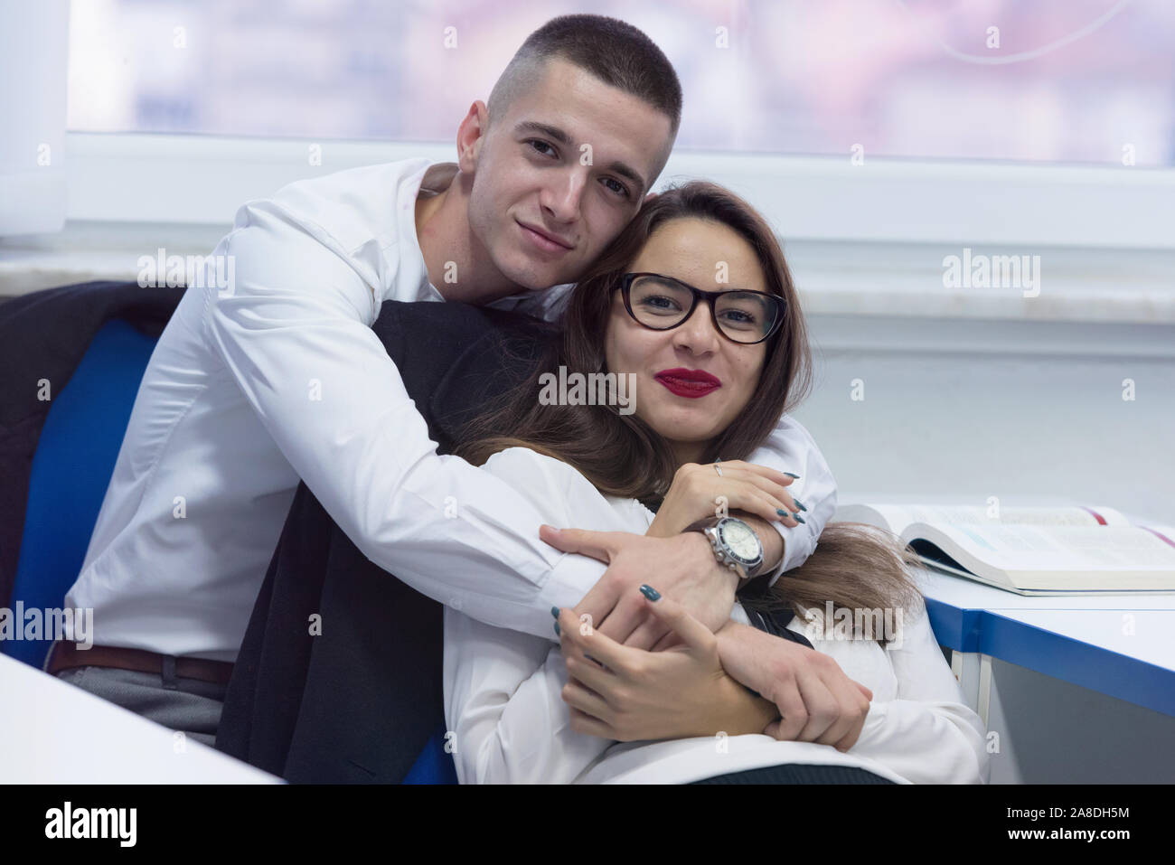 Loving life on campus. Young couple on campus during class in classroom ...