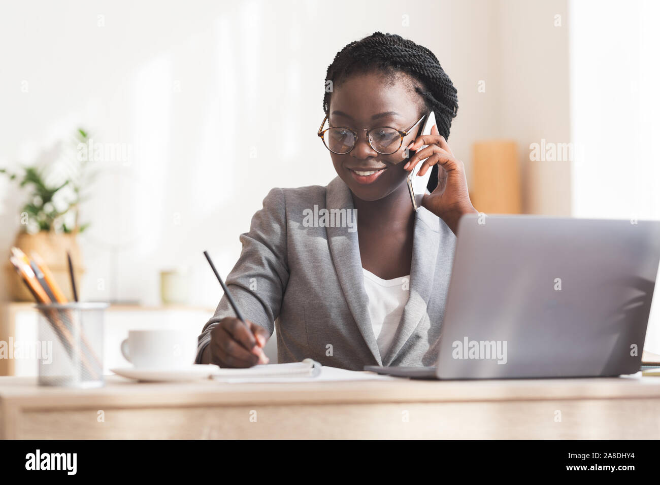 Afro Secretary Talking On Phone And Taking Notes At Workplace Stock ...